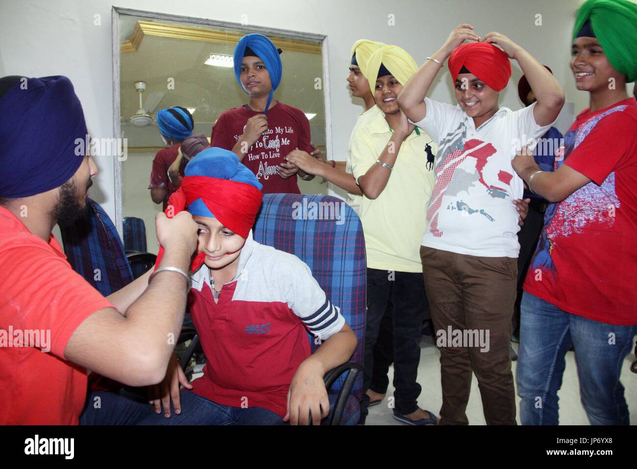 Sikh children attend a free tutoring session on how to wear a turban ...