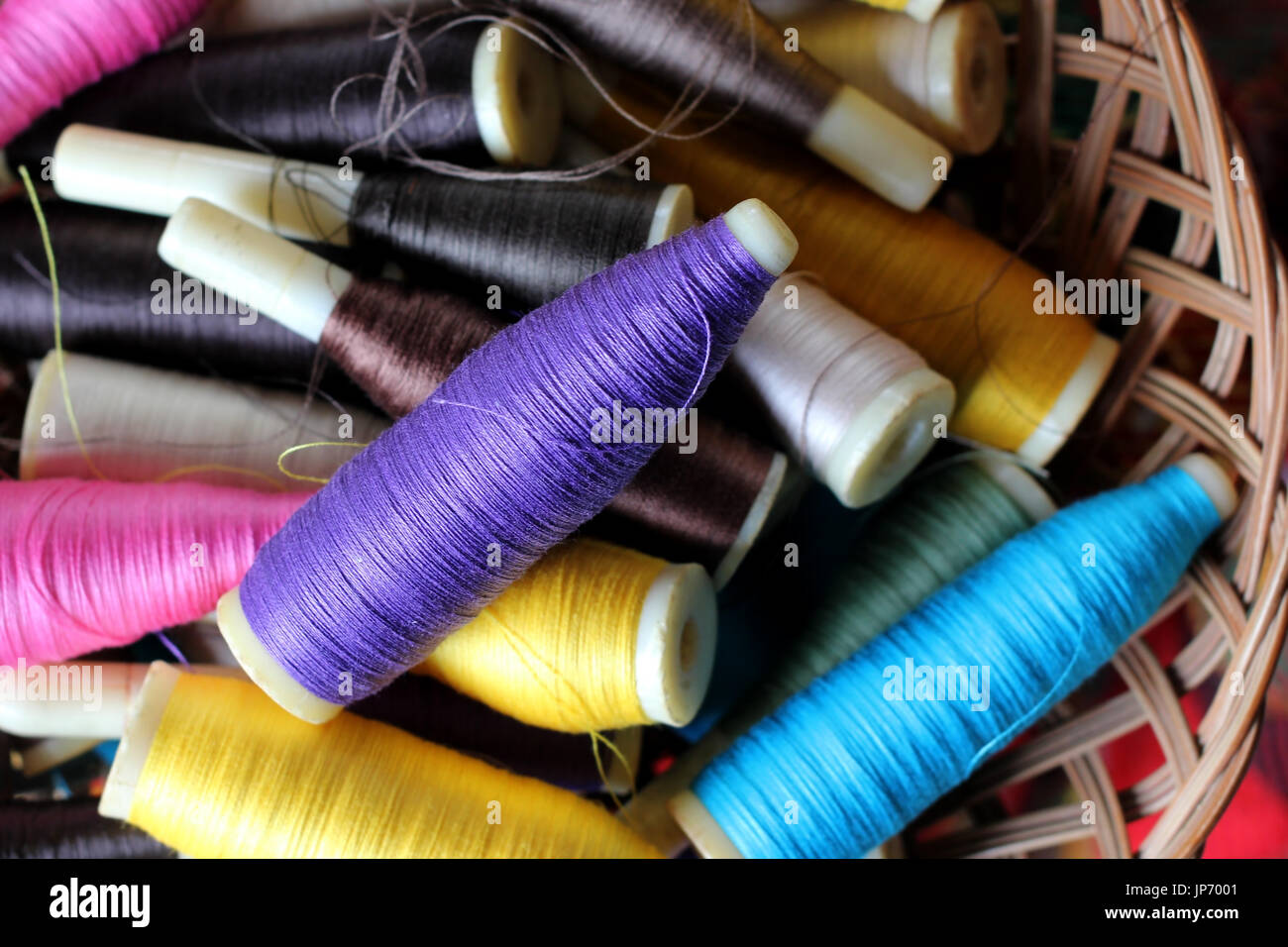 colorful bobbins of thread in basket Stock Photo - Alamy