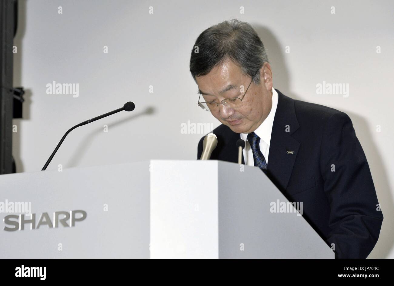 Sharp Corp. President Kozo Takahashi bows his head at a press ...
