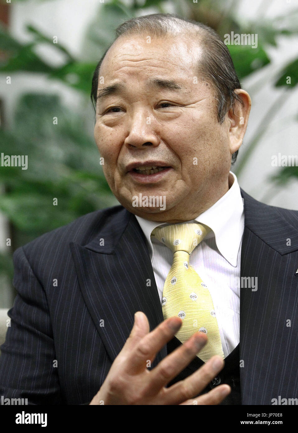 Takaaki Ikeda, owner of a travel agency in Tokyo, speaks in an ...