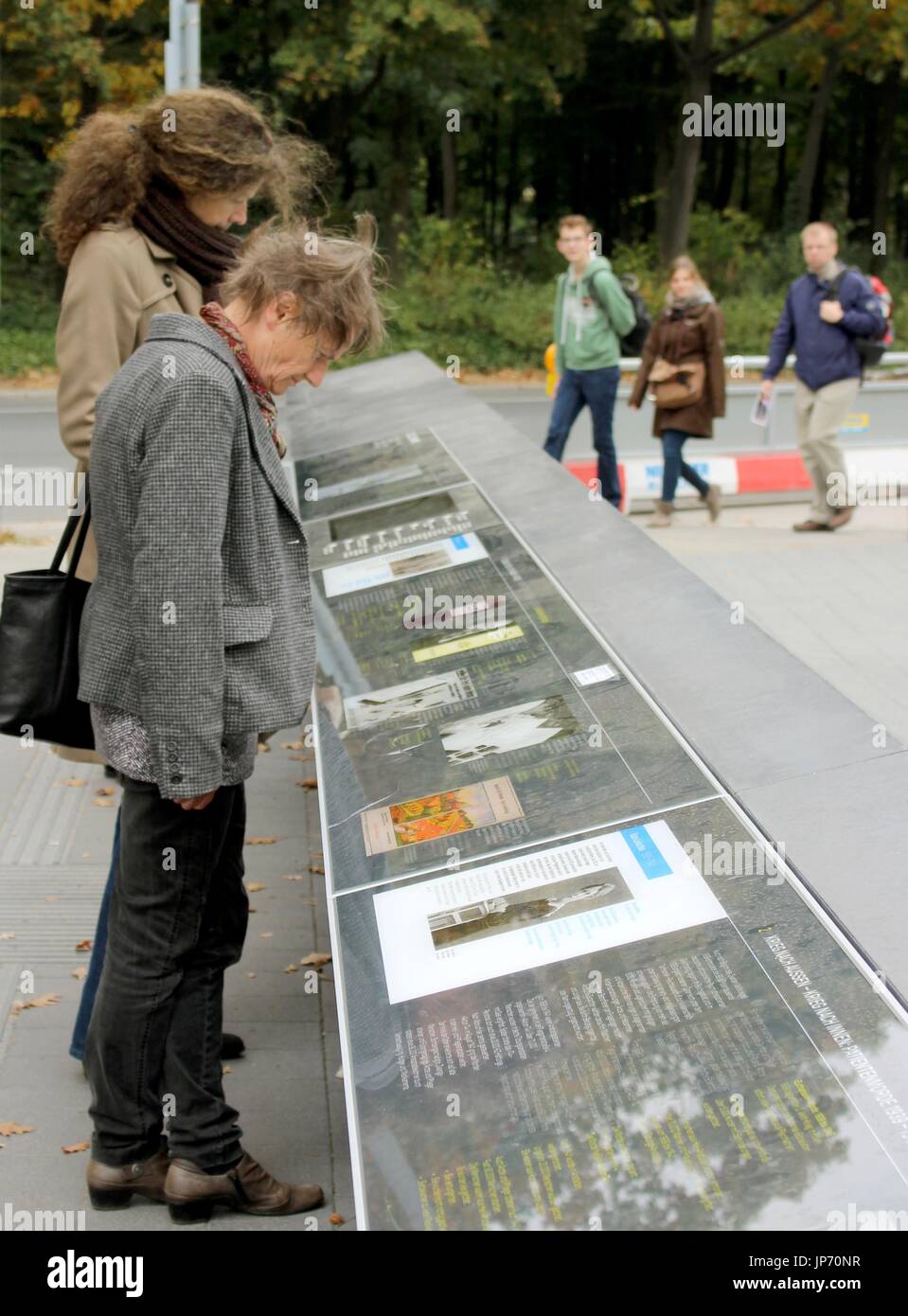 Visitors look at the display of photos, documents and other records at ...