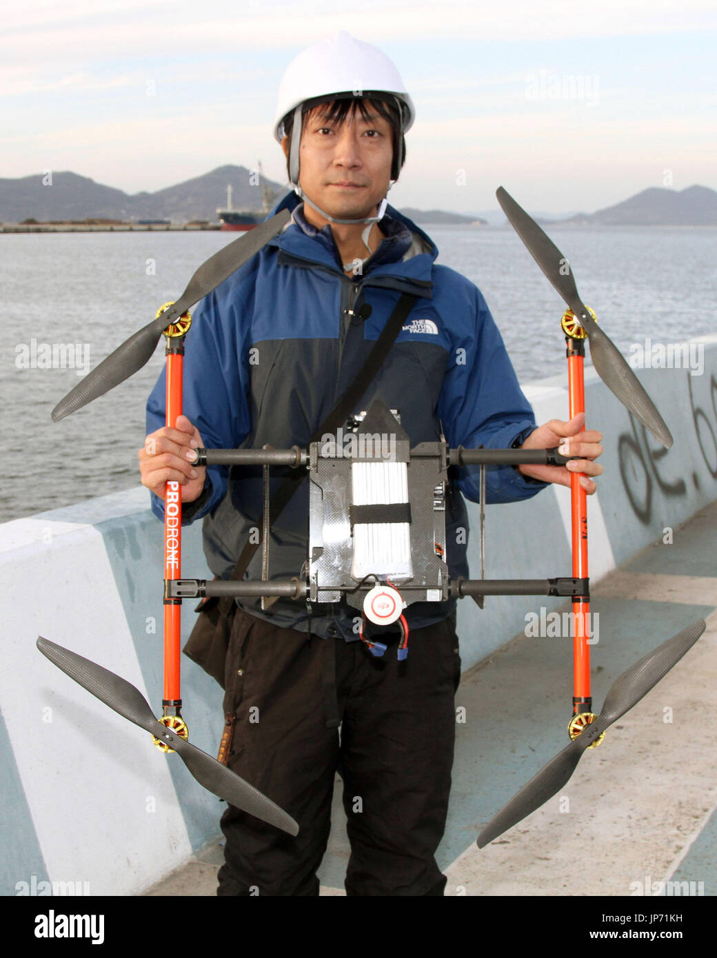 Masato Ono, leader of the "KamomeAir Project," holds a drone his team ...