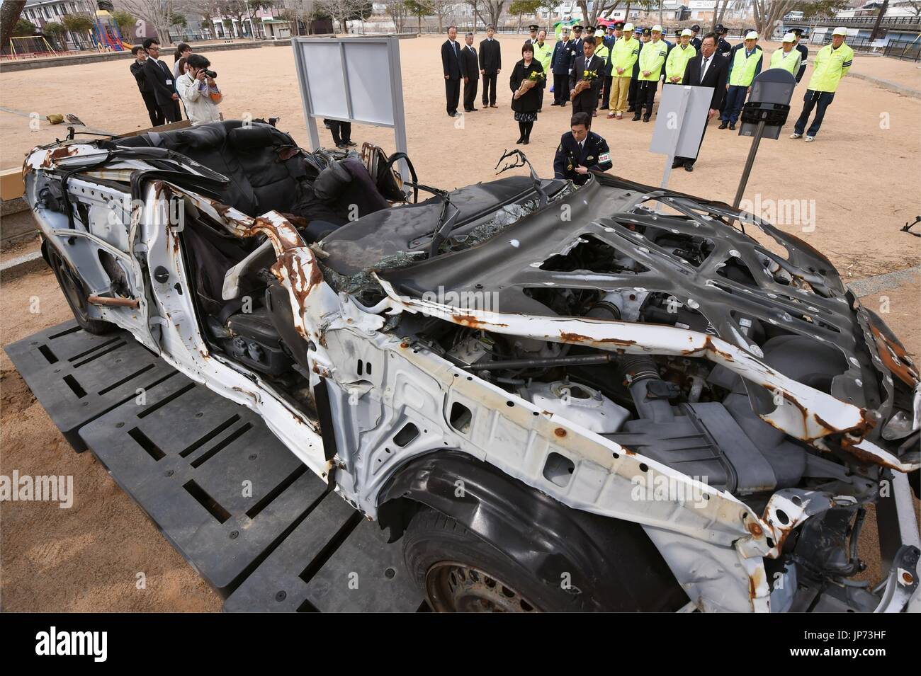 The wreckage of a police car hit by a tsunami is on display at a park ...