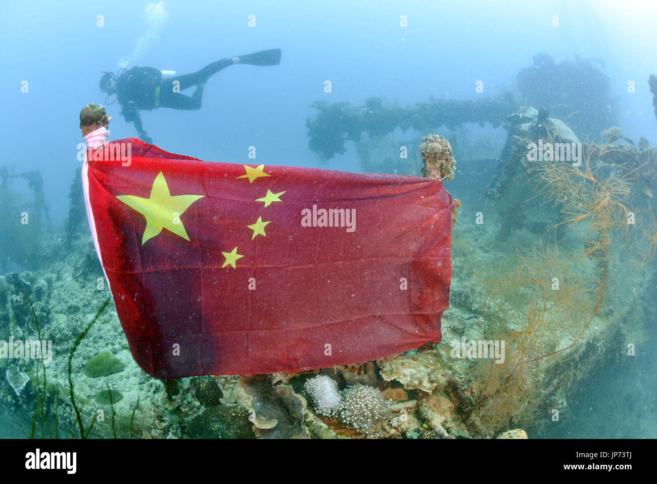 A Chinese national flag is seen tied to the wreckage of the fleet oiler ...