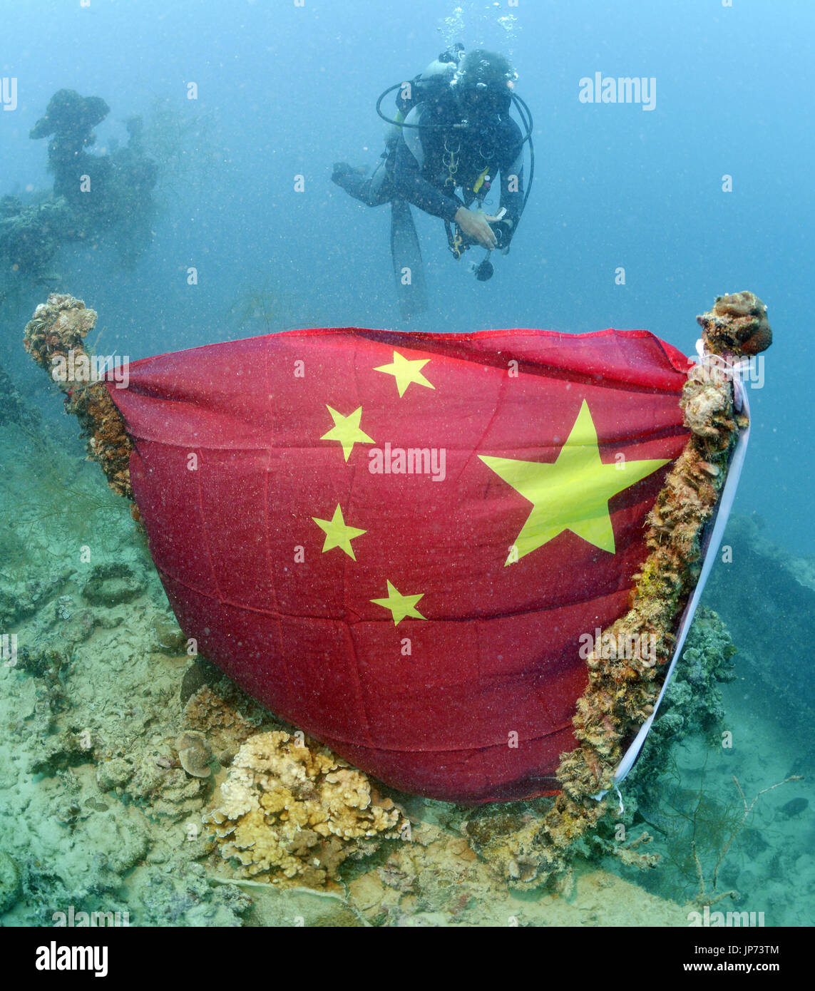A Chinese national flag is seen tied to the wreckage of the fleet oiler ...