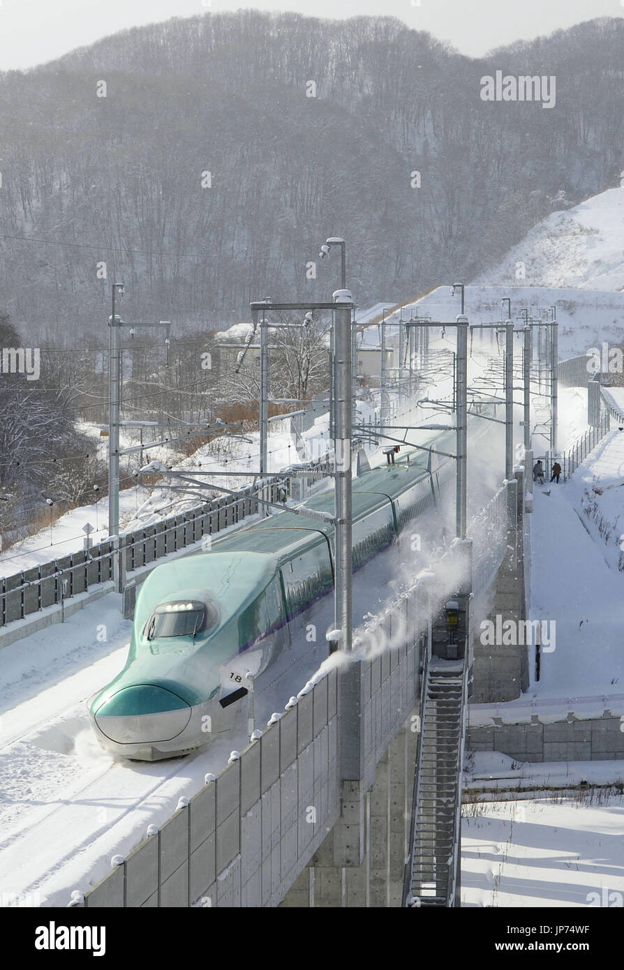 An H5 series bullet train for the Hokkaido Shinkansen Line makes a ...