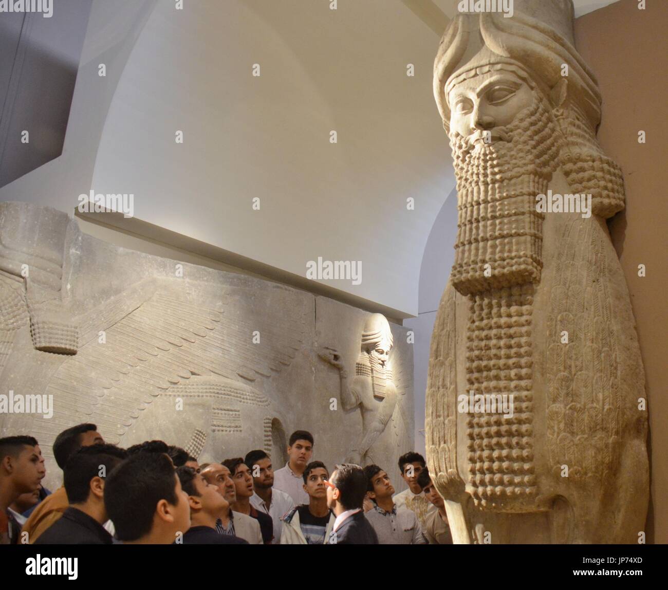 High school students and other visitors observe the 4-meter-high statue ...