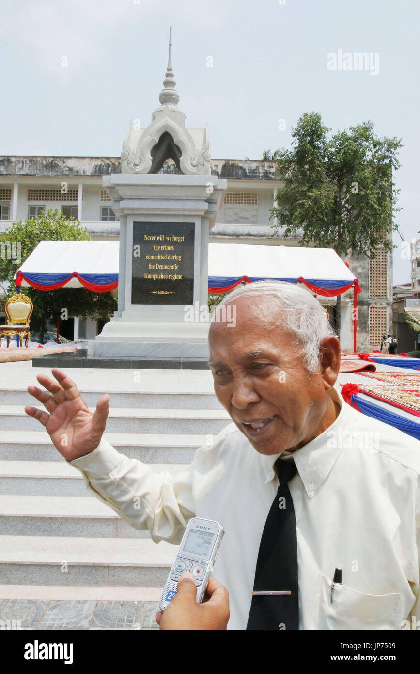 Chum Mey, former political inmate, speaks in front of a memorial for ...