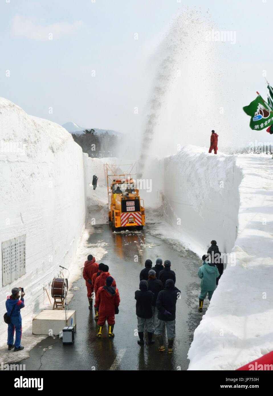 Snow is expelled from a road at Kasamatsu pass in Aomori Prefecture ...