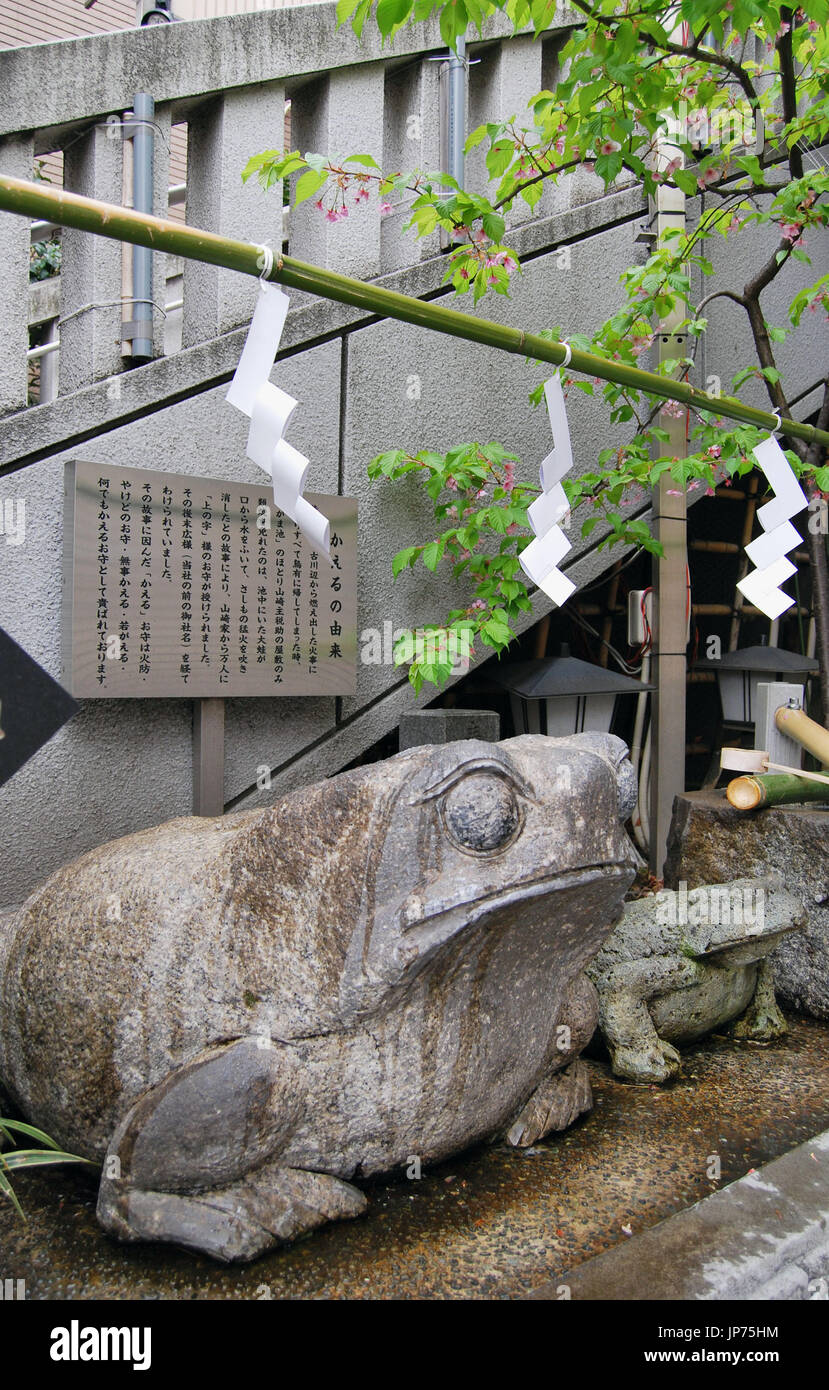 Stone frogs in different sizes at Juban Inari Jinja, a Shinto shrine in ...