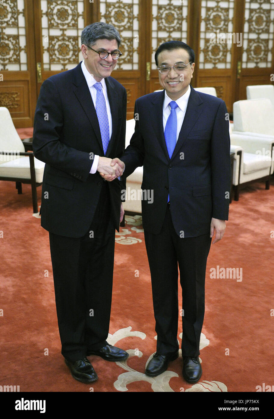 U.S. Treasury Secretary Jacob Lew (L) shakes hands with Chinese Premier ...