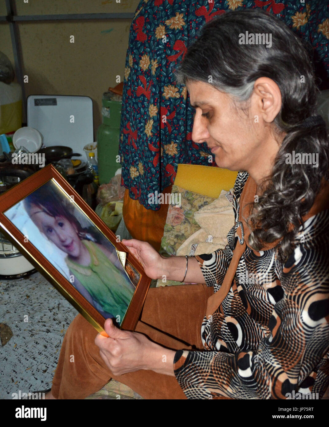 An Iraqi woman living in a temporary shelter for refugees in Arbil, a ...