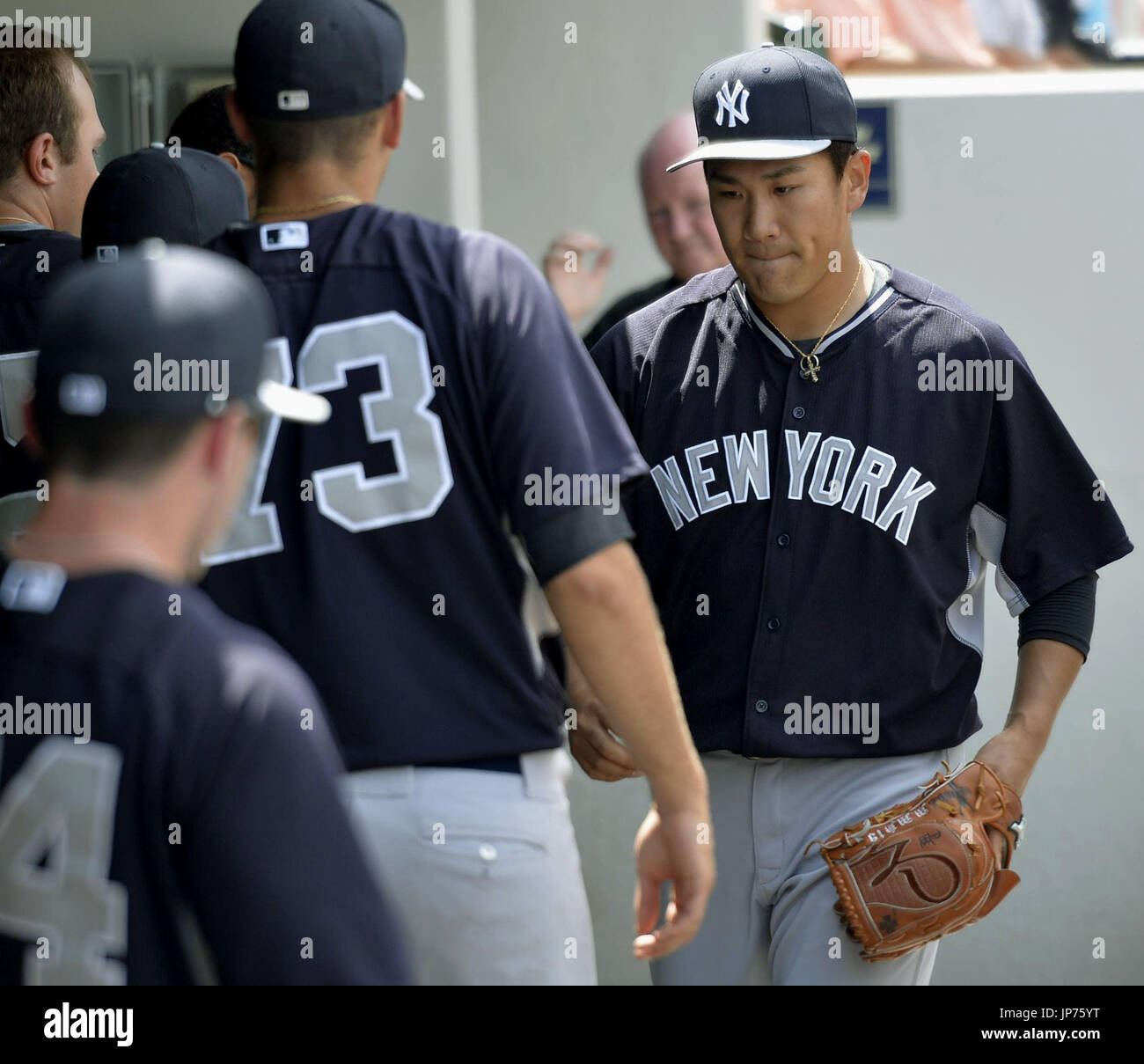 New York Yankees pitcher Masahiro Tanaka returns to the dugout after giving up three runs on ...