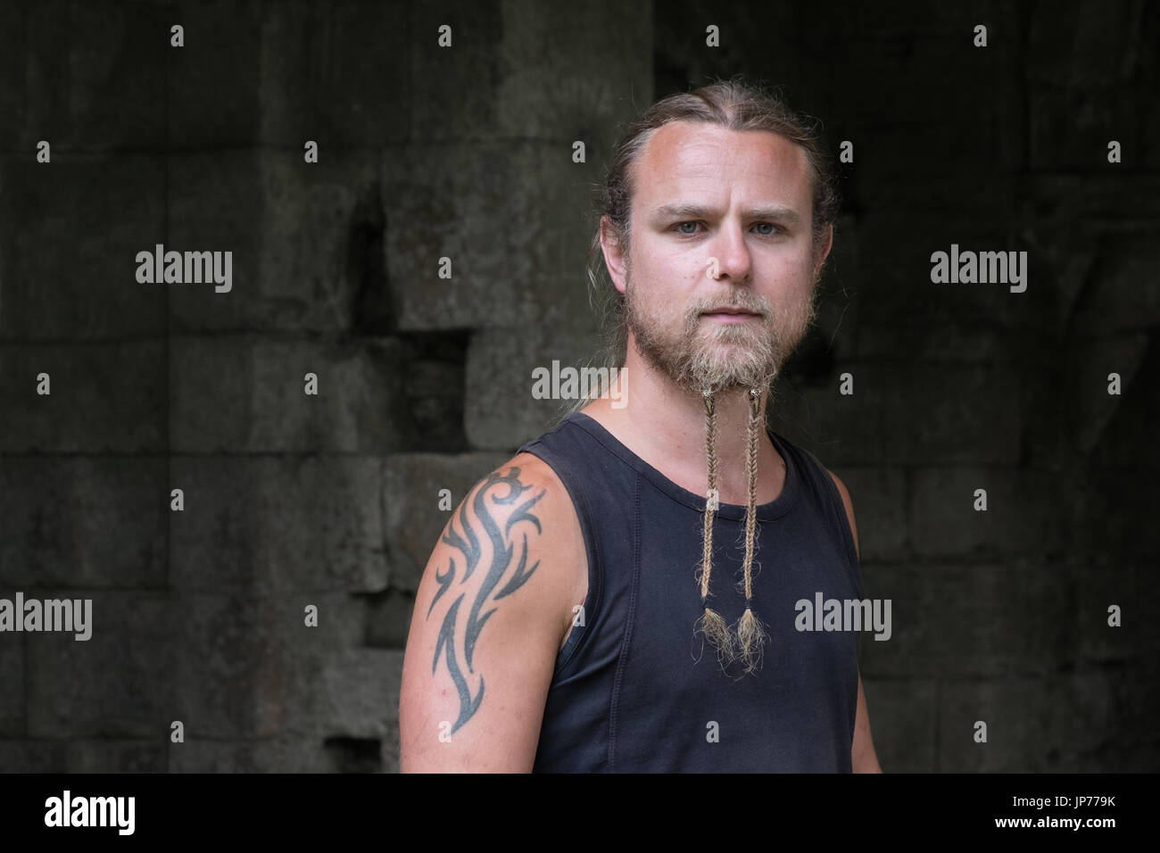 Young man with plaited beard and tattoo Stock Photo - Alamy