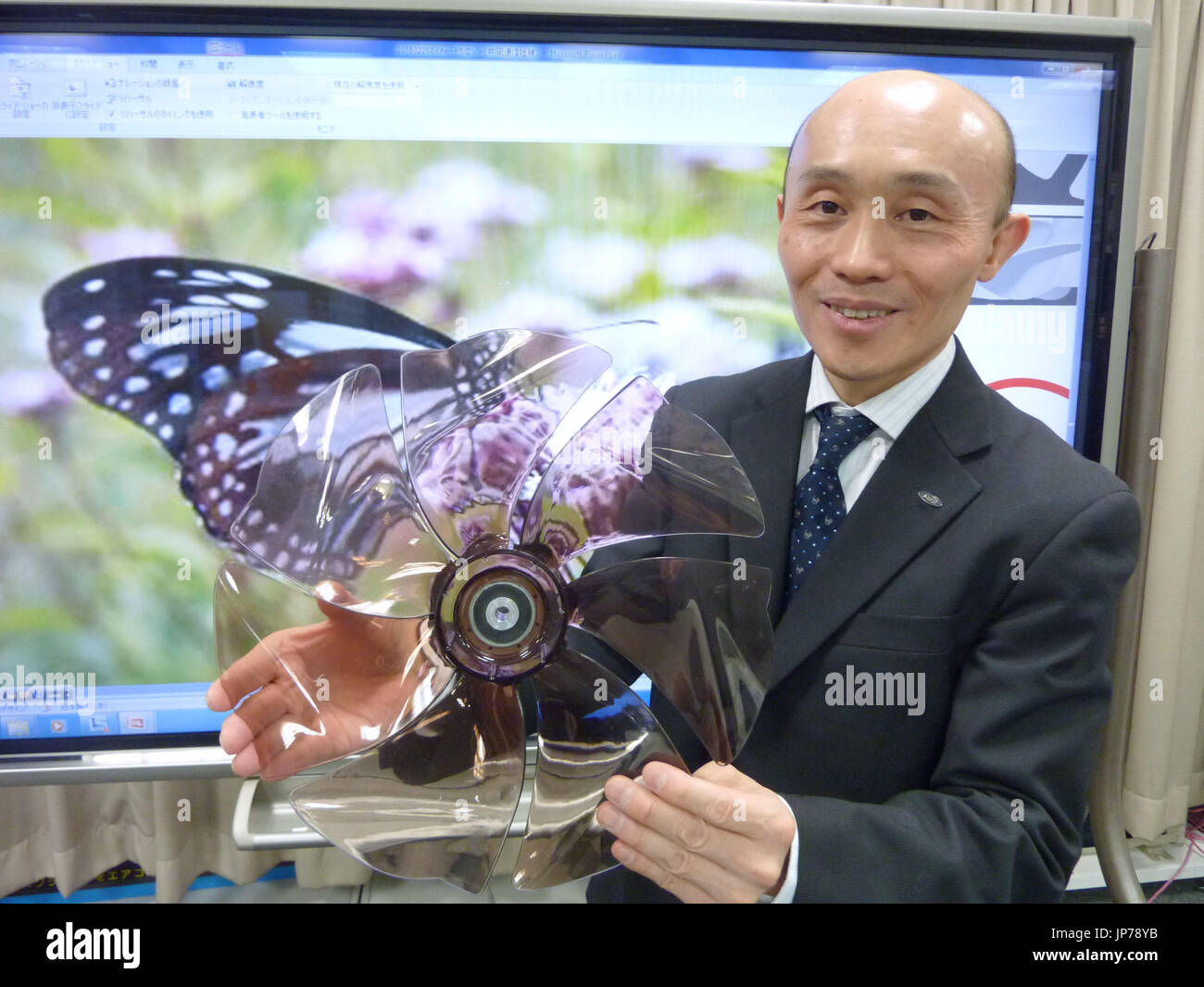Sharp Corp. employee Masaki Otsuka in February 2015 shows an electric ...