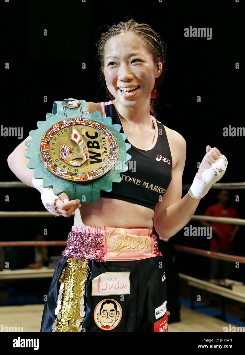 Japan's Yuko Kuroki wearing her champion belt poses for a photo after beating compatriot Masae ...