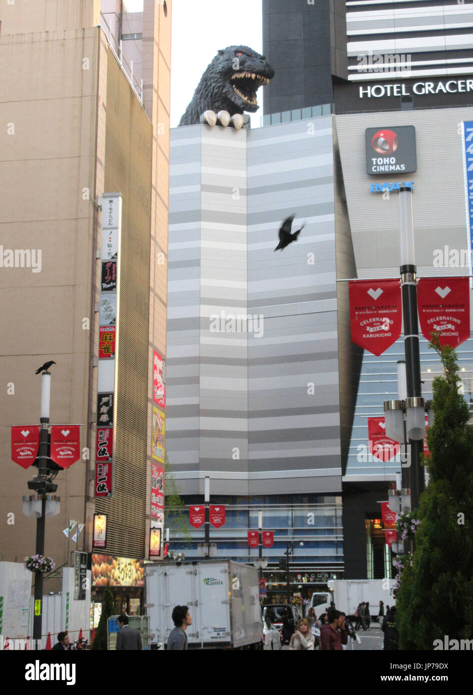 A "life-size" Godzilla head appears as if looking down on Tokyo's major ...