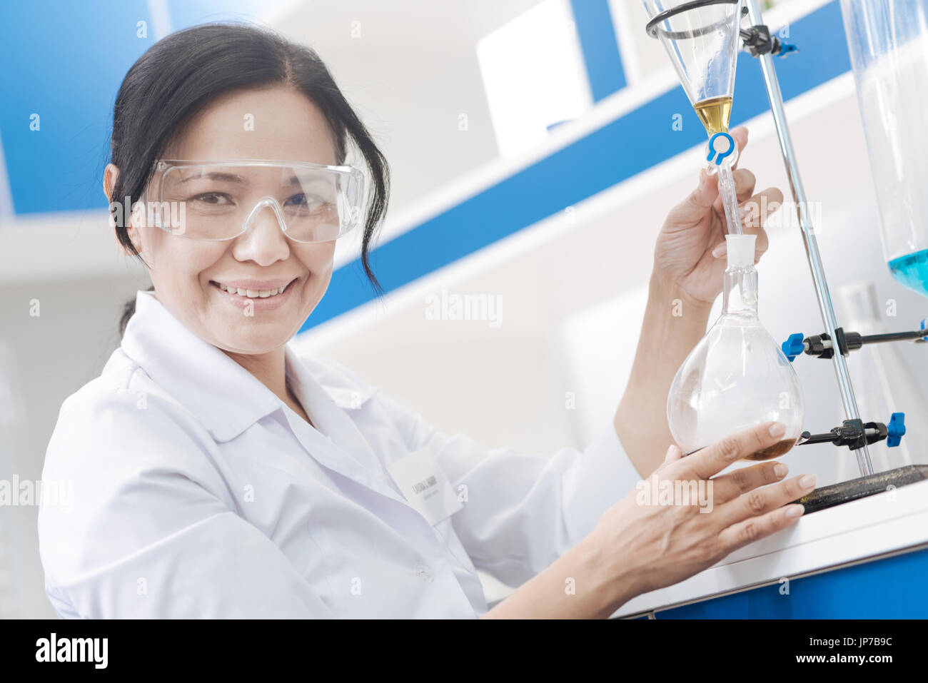 Positive female biochemist working in the lab Stock Photo - Alamy
