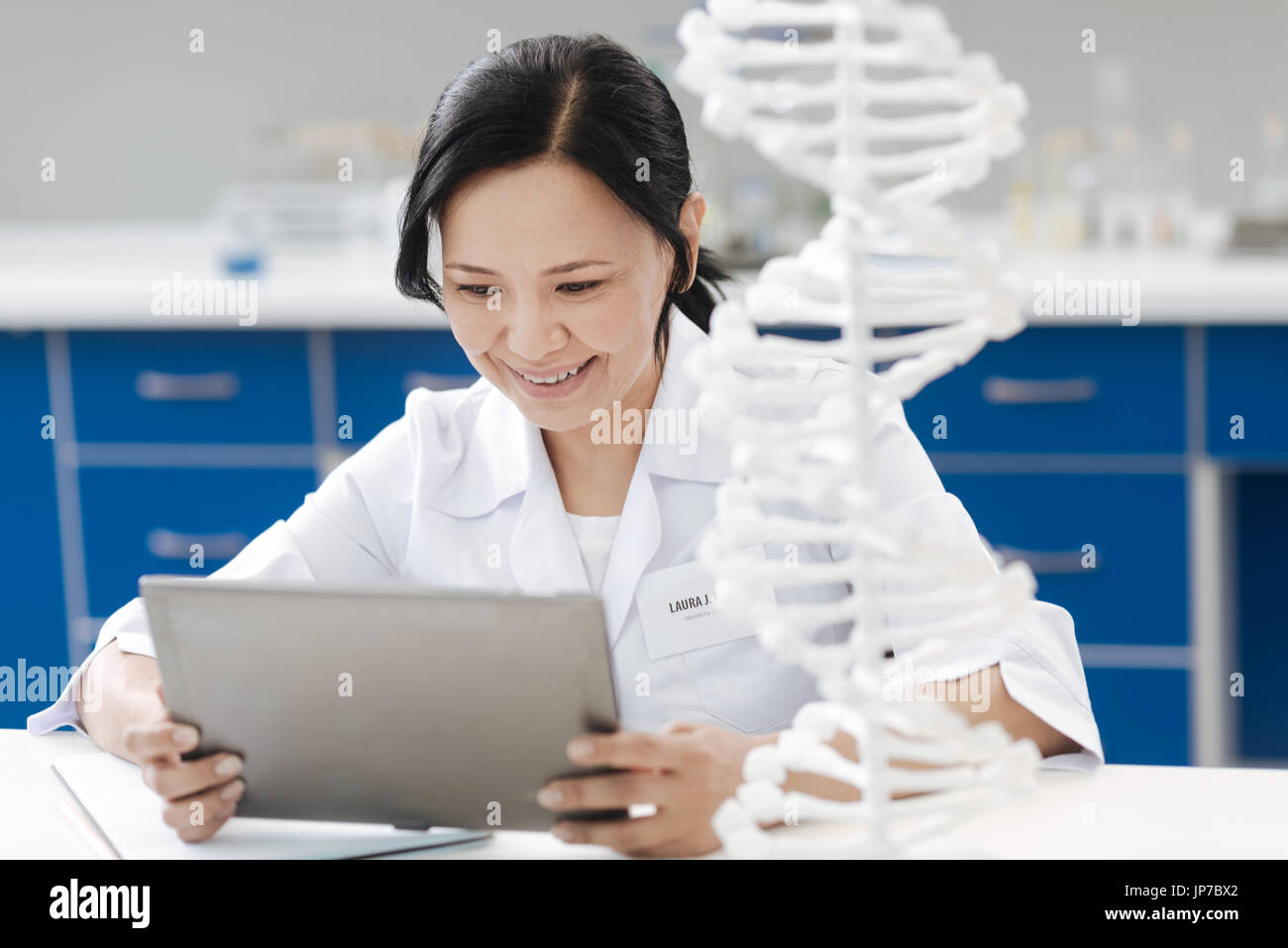 Joyful genetic scientist using a tablet Stock Photo - Alamy