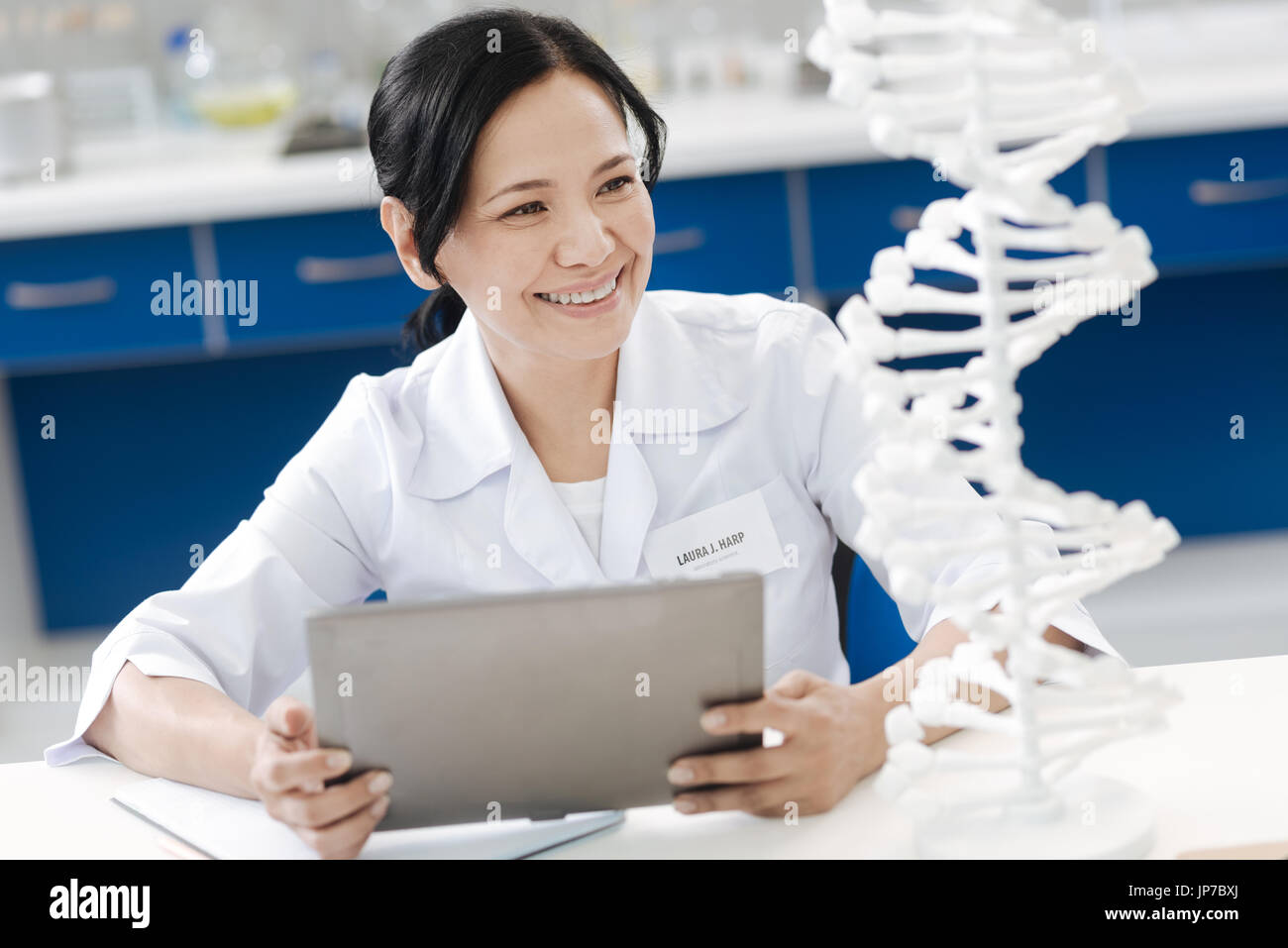 Delighted professional scientist smiling Stock Photo - Alamy