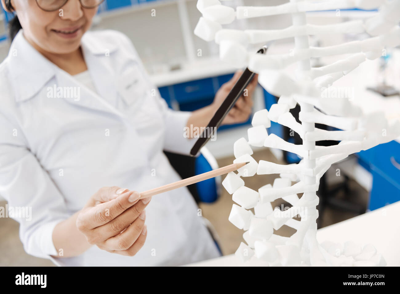 Professional female scientist holding a pencil Stock Photo - Alamy