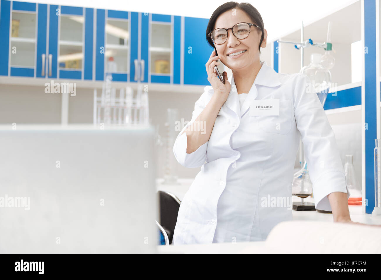 Cheerful good looking woman making a call Stock Photo - Alamy