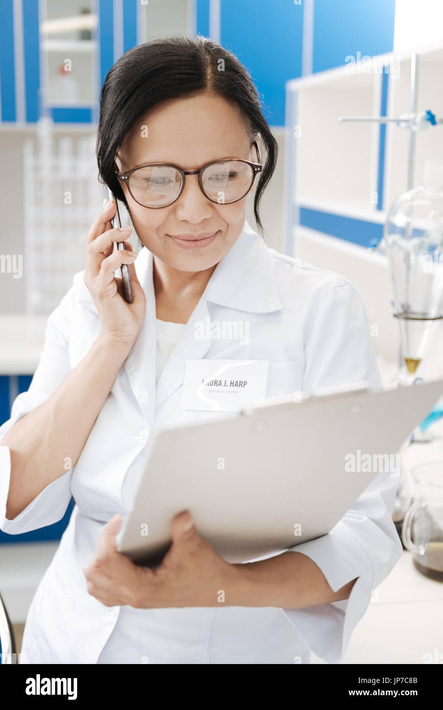 Positive nice woman consulting with her colleague Stock Photo - Alamy