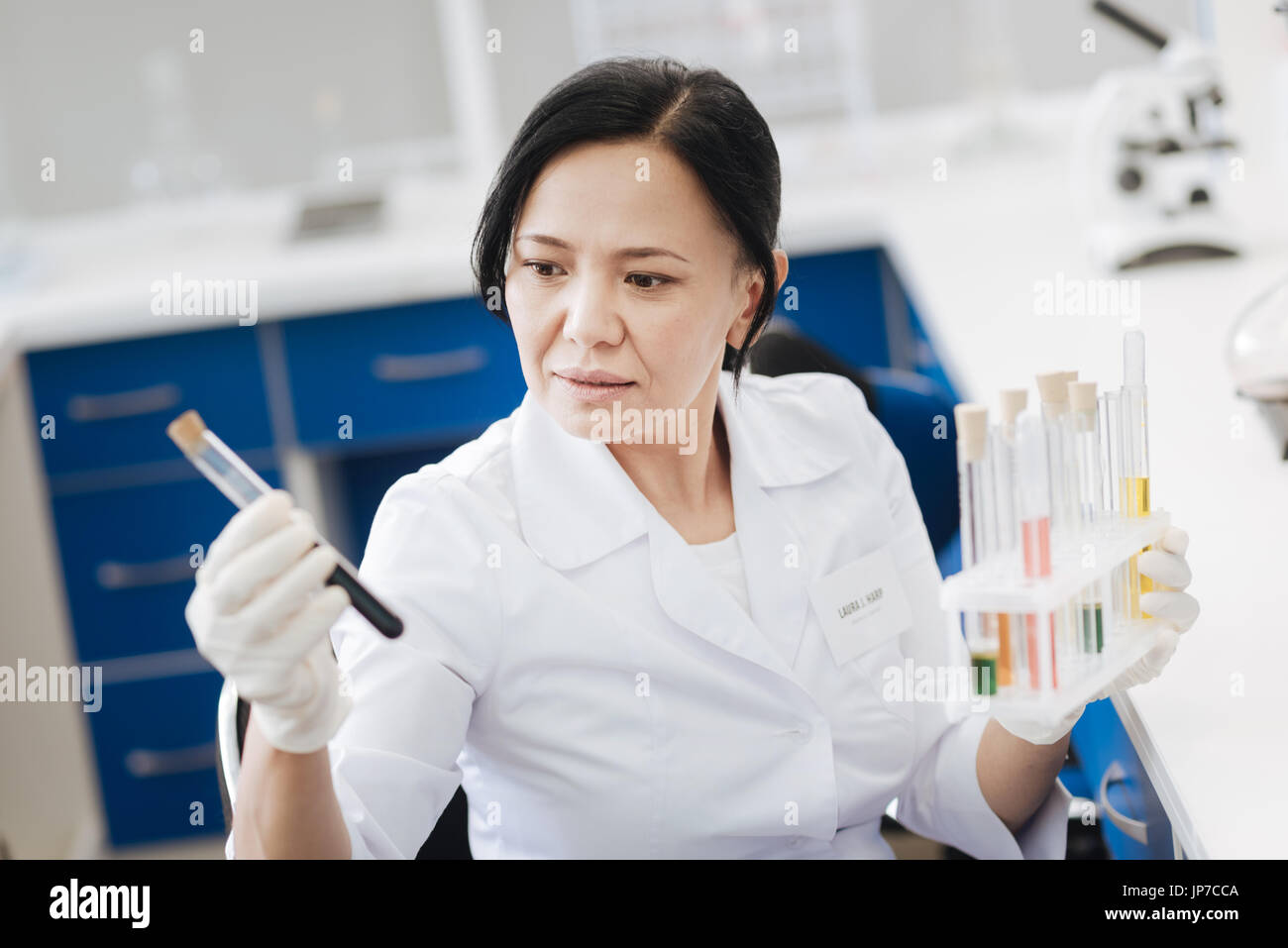 Nice serious woman working in a chemical lab Stock Photo - Alamy