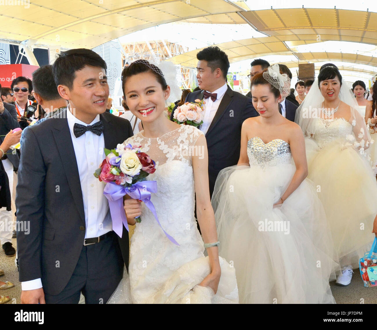 Twelve Chinese couples walk around the Expo 2015 in Milan, Italy, on ...