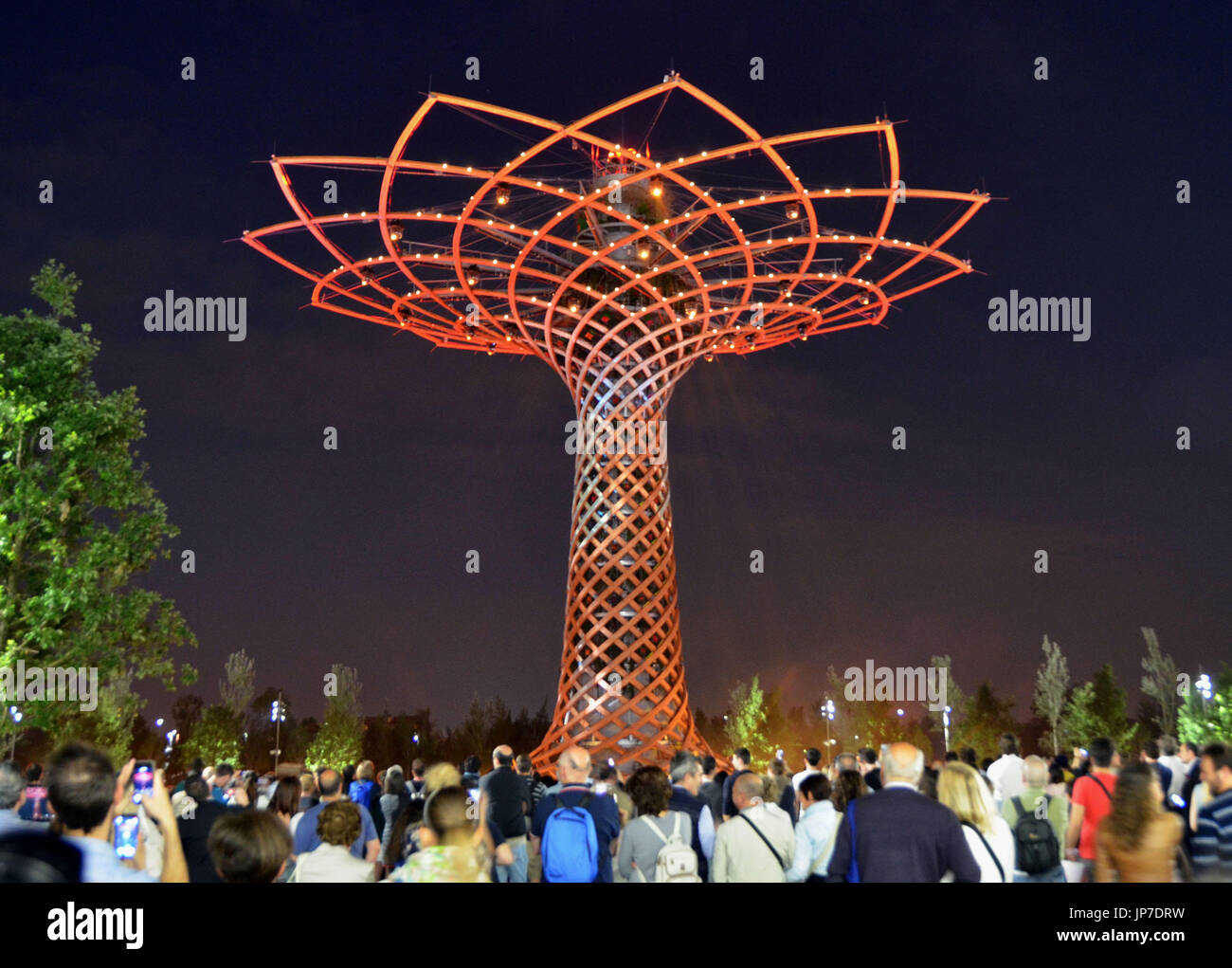 People gather around the lit-up "Tree of Life," a 35-meter high ...