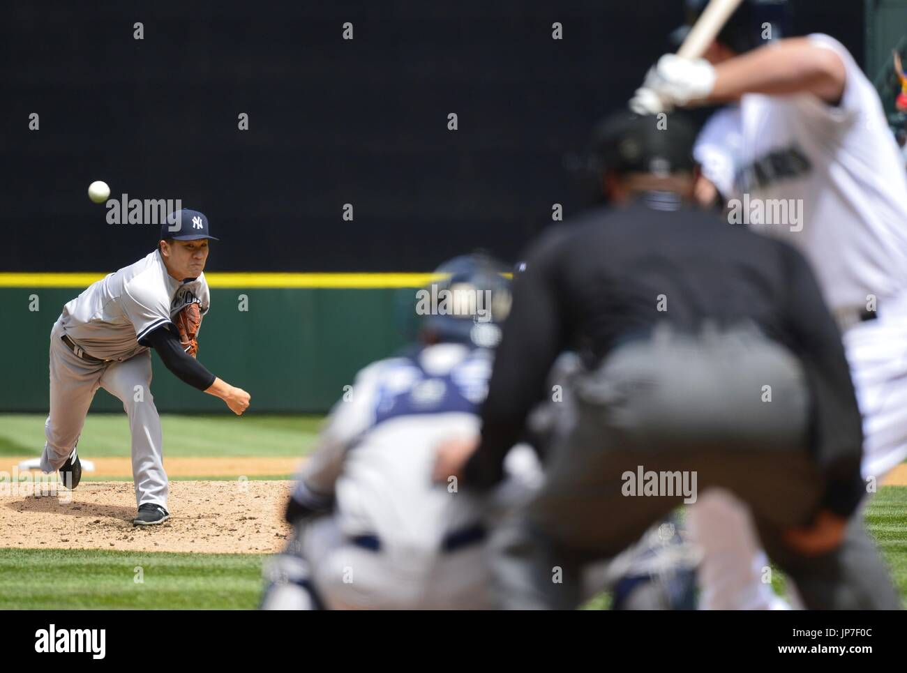 New York Yankees starter Masahiro Tanaka throws against Kyle Seager of ...