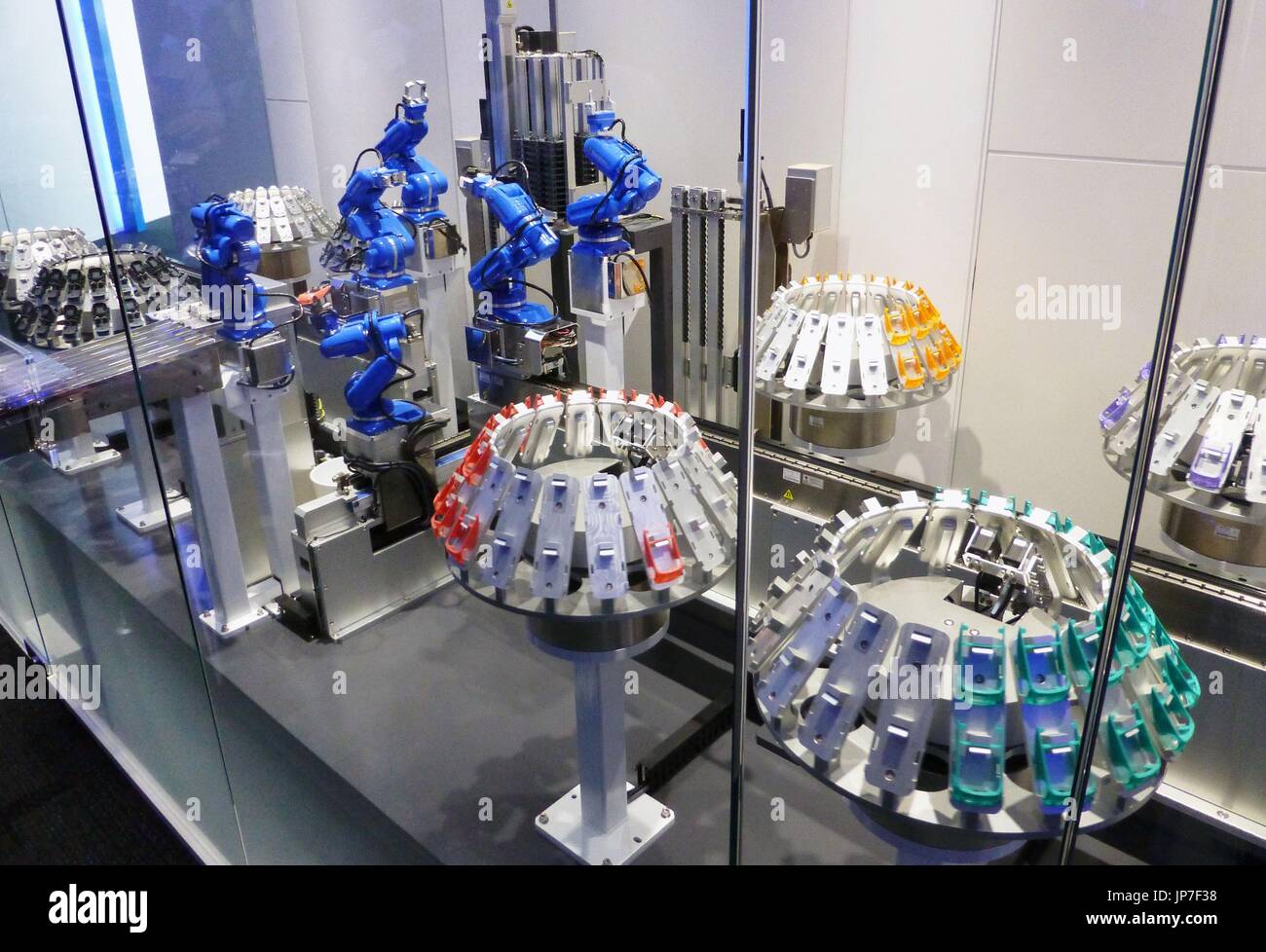 A robot assembles toy cars at Yaskawa Electric Corp.'s "Robot Village ...