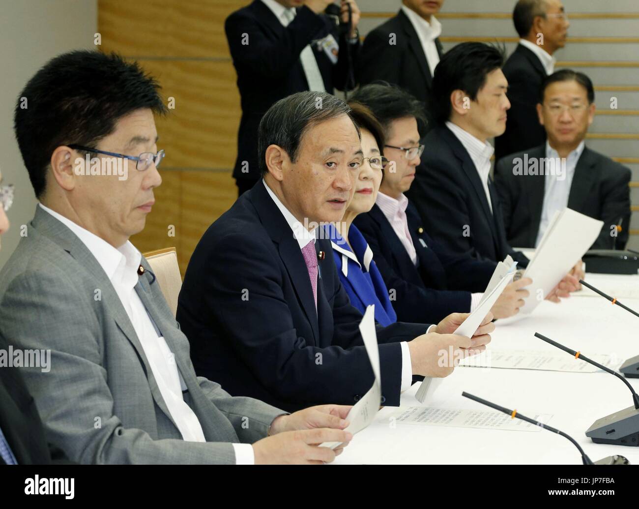 Chief Cabinet Secretary Yoshihide Suga (2nd from L) attends a meeting ...