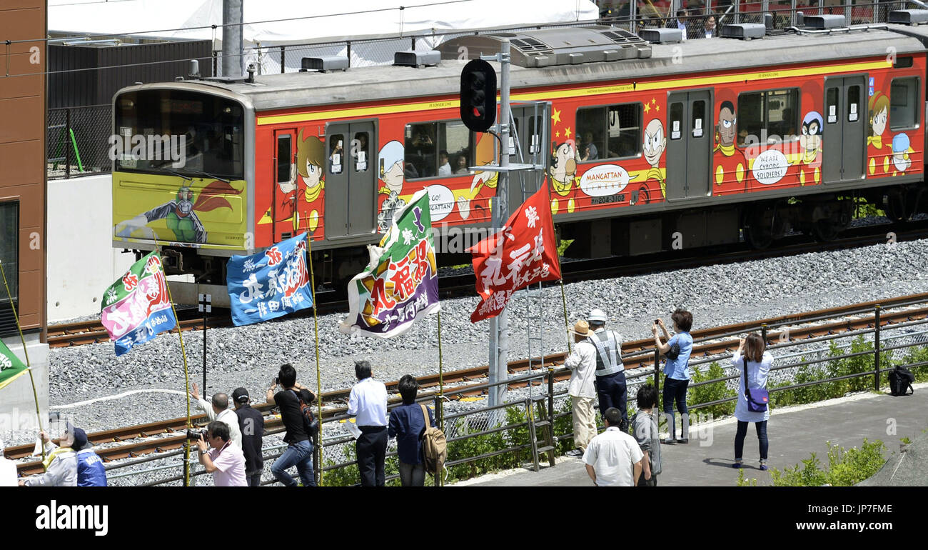 Local residents celebrate with flags the resumption of full train ...