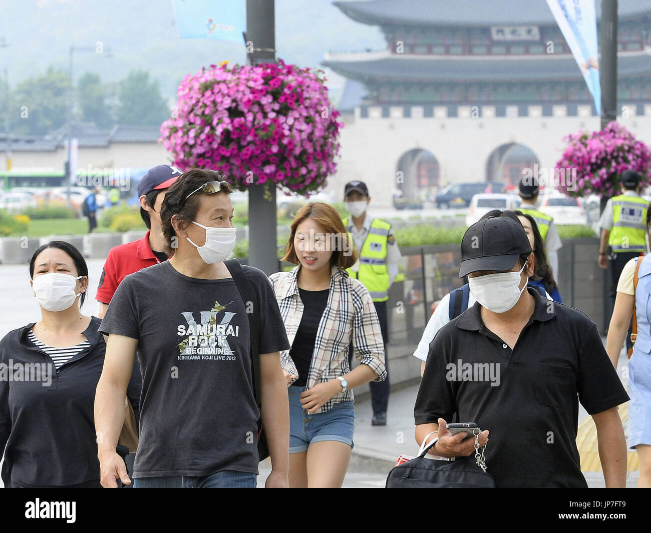 People walk in downtown Seoul on June 8, 2015, wearing masks amid ...