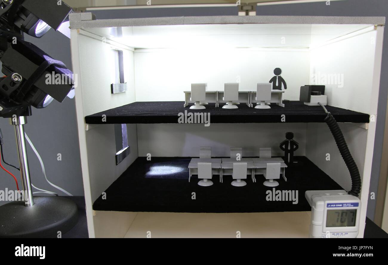 A model shows how a special film developed by Sharp Corp. attached to ...