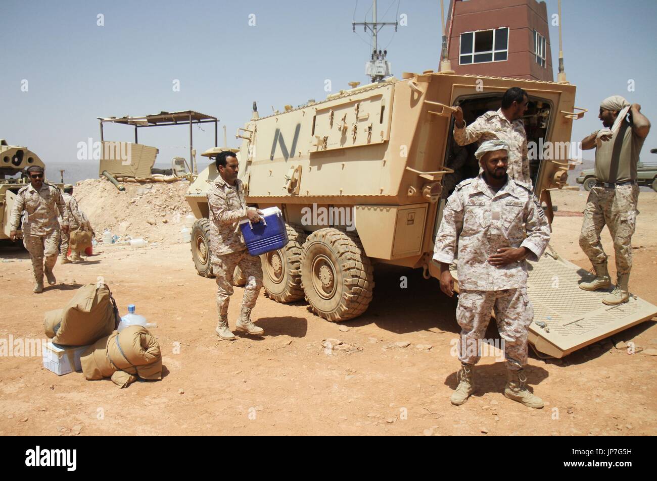 Saudi Arabia's border guards load food and water into an armored ...
