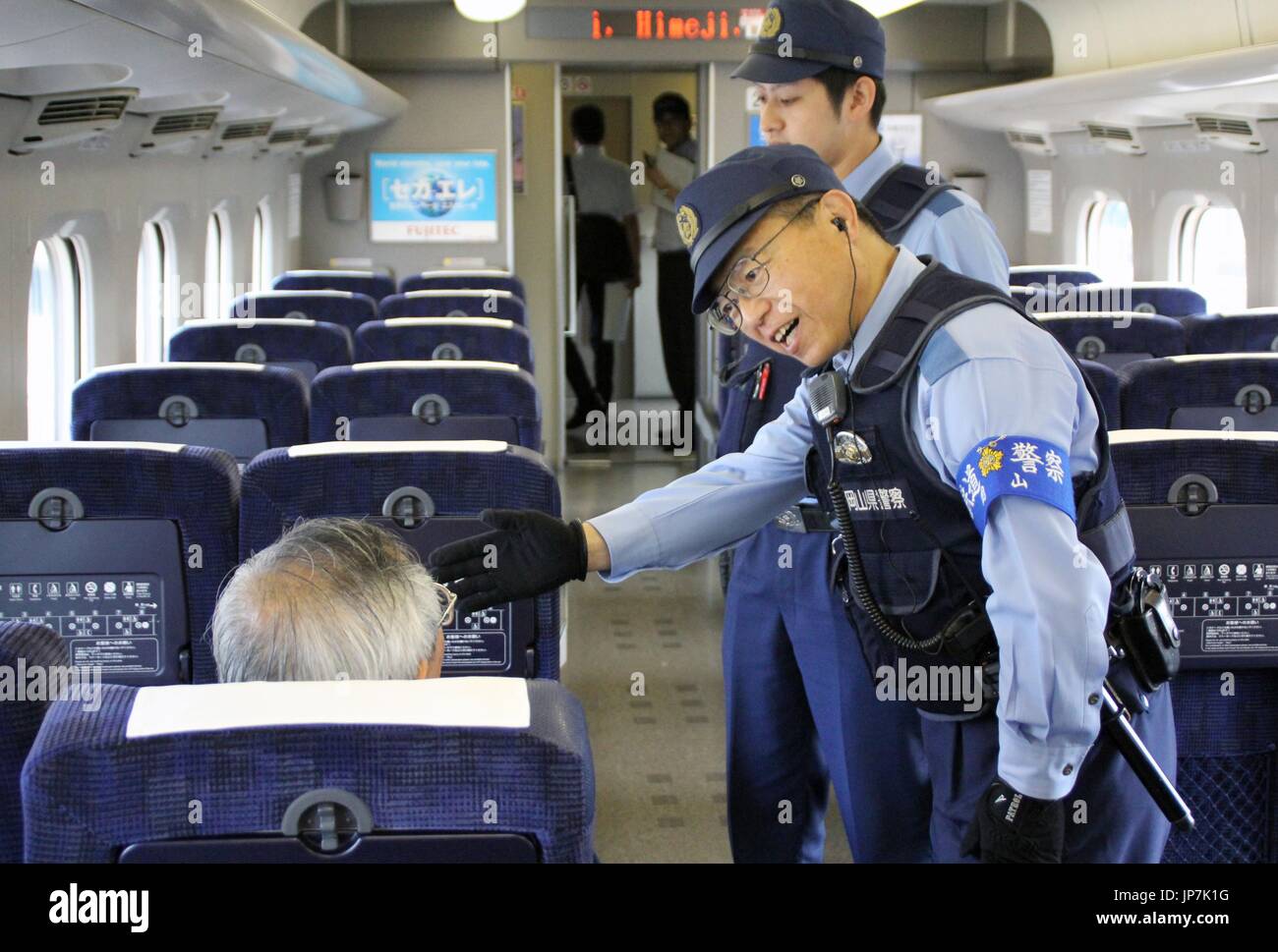 Police officers patrol on a shinkansen bullet train on July 3, 2015 ...
