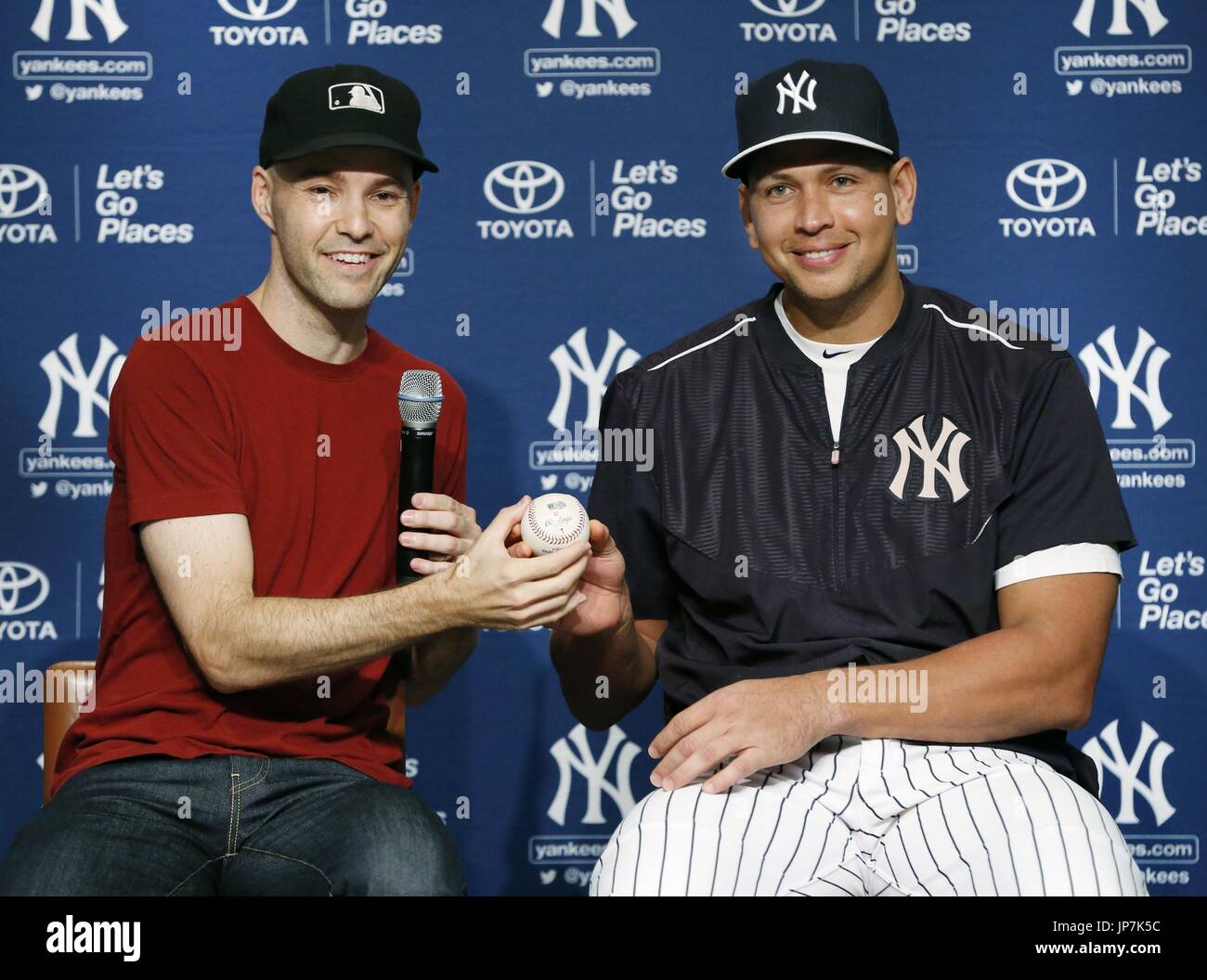 Alex Rodriguez (R) of the New York Yankees receives the ball of his 3,000th career hit -- a home ...