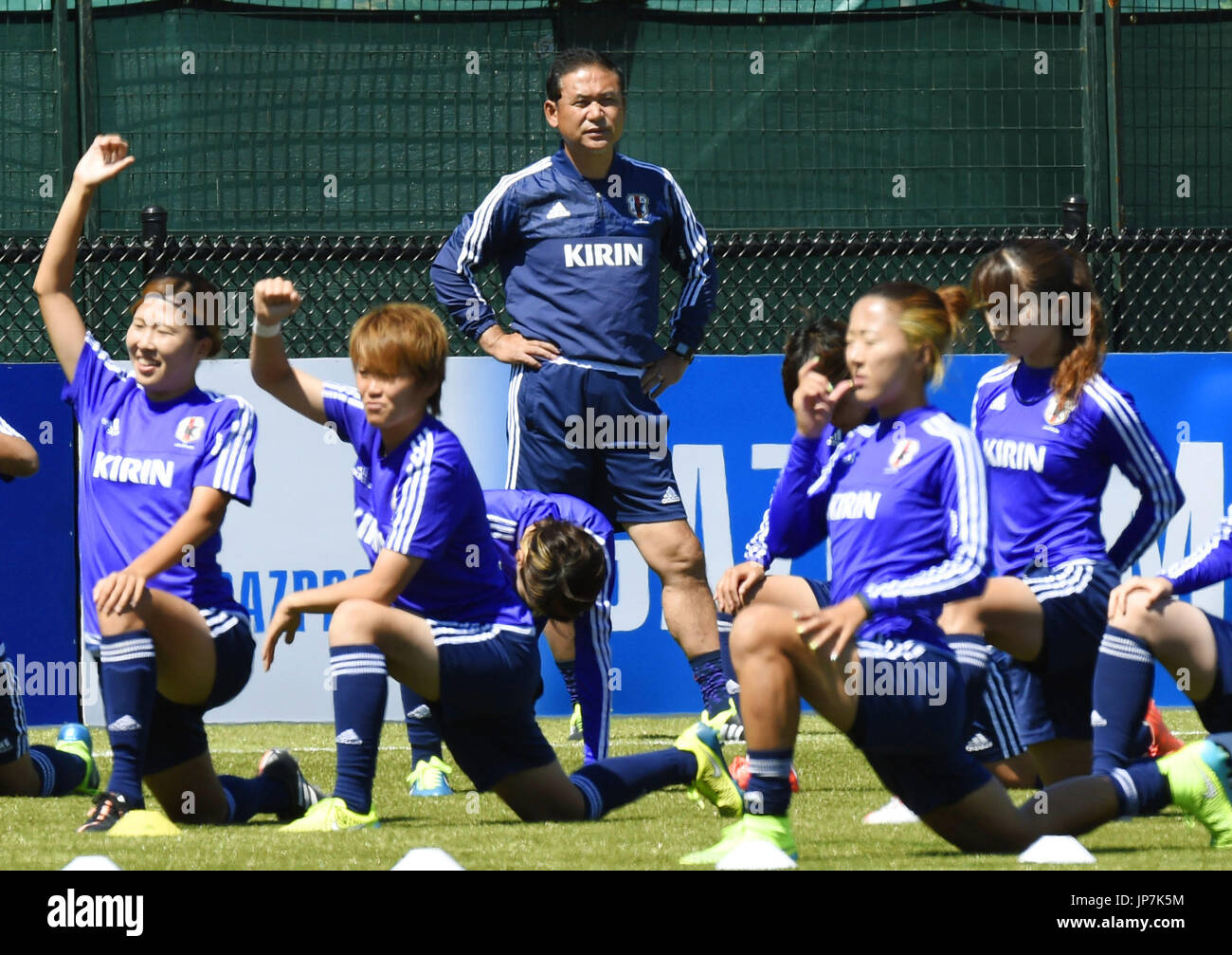 Japanese soccer coach Norio Sasaki (standing in back) sees his players ...