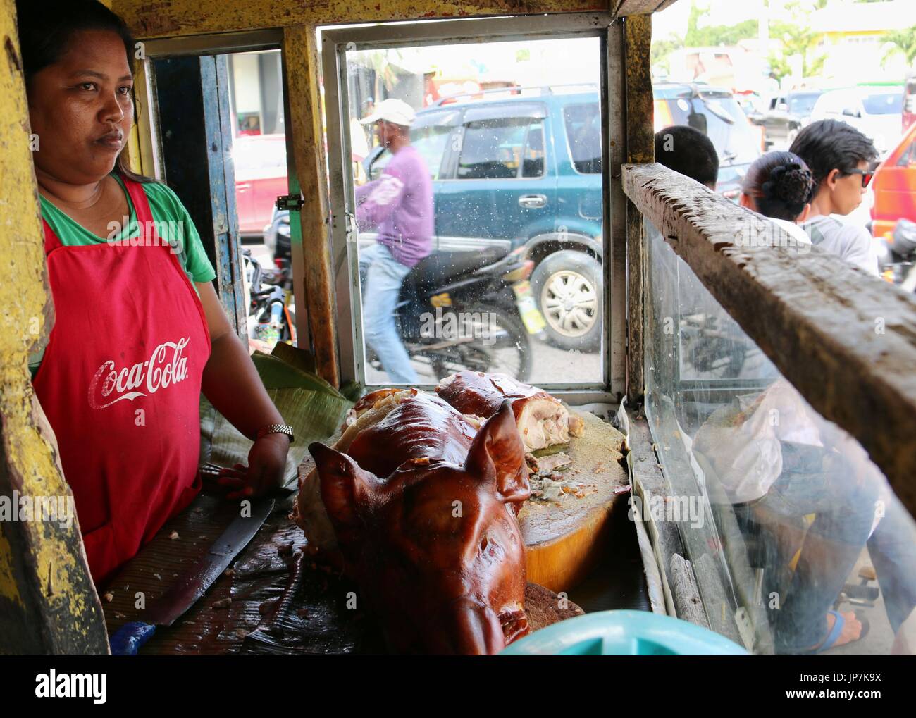 The lechon traditional roasted pig is displayed conspicuously along a ...