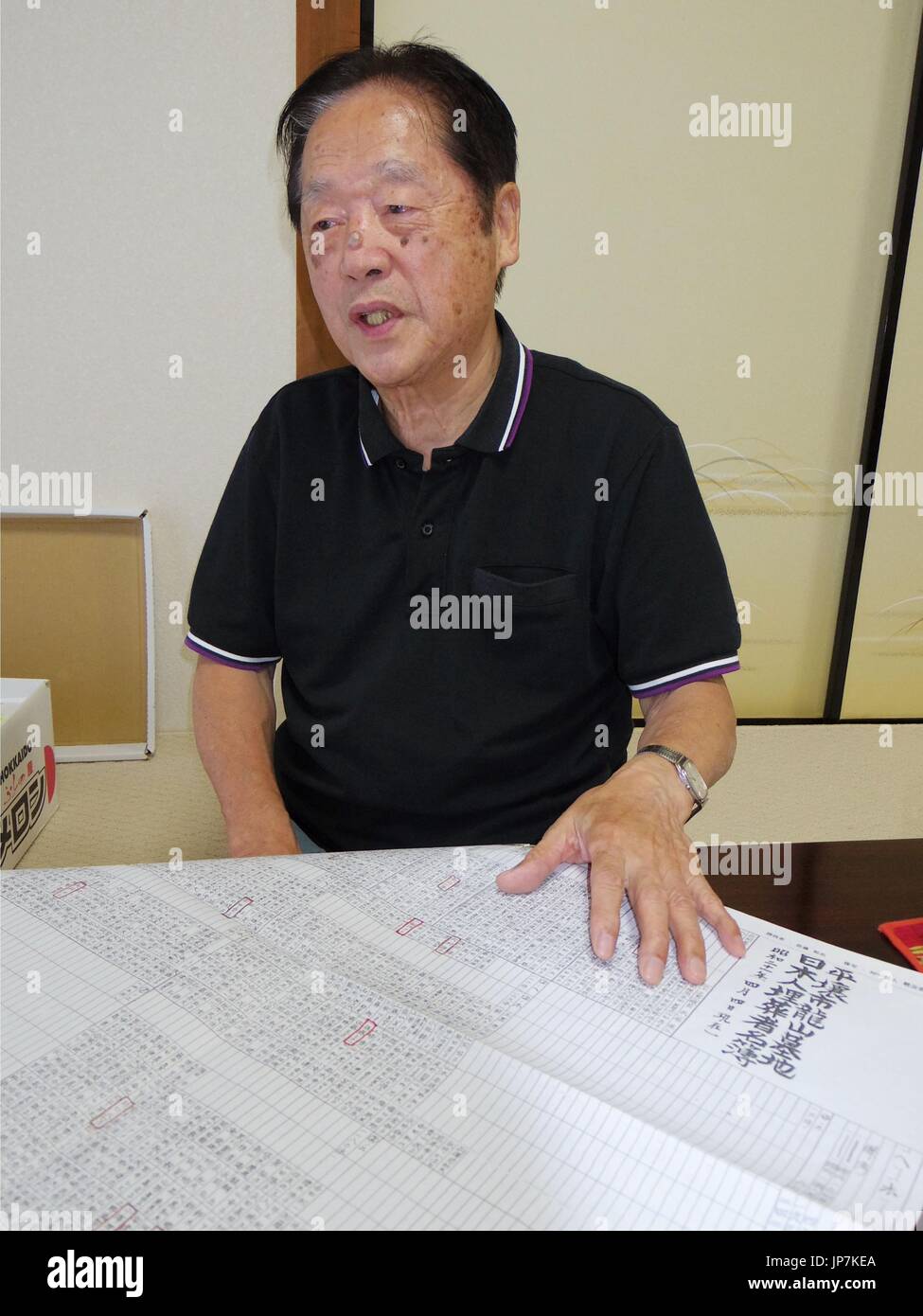 Tomoya Sato shows a name list of Japanese nationals buried in the Yongsan grave site near ...
