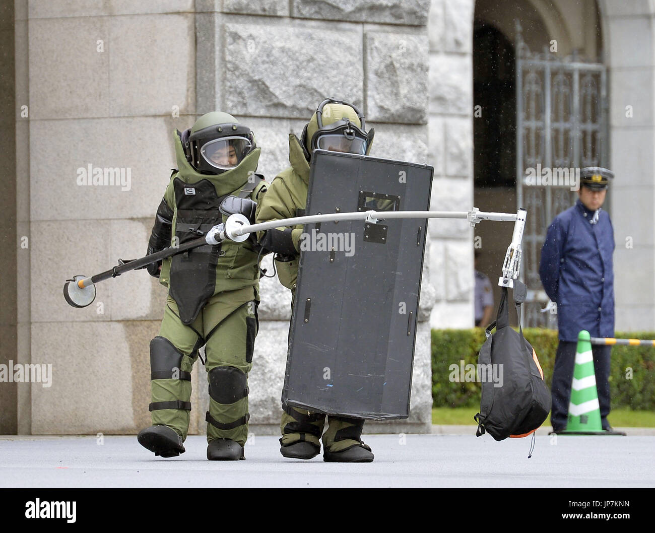 Bomb disposal experts carry a dummy explosive out of the National Diet ...