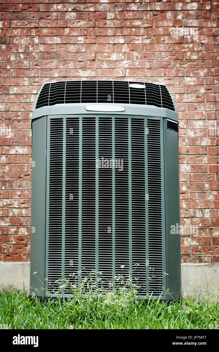 High efficiency modern AC-heater unit on brick wall background Stock ...