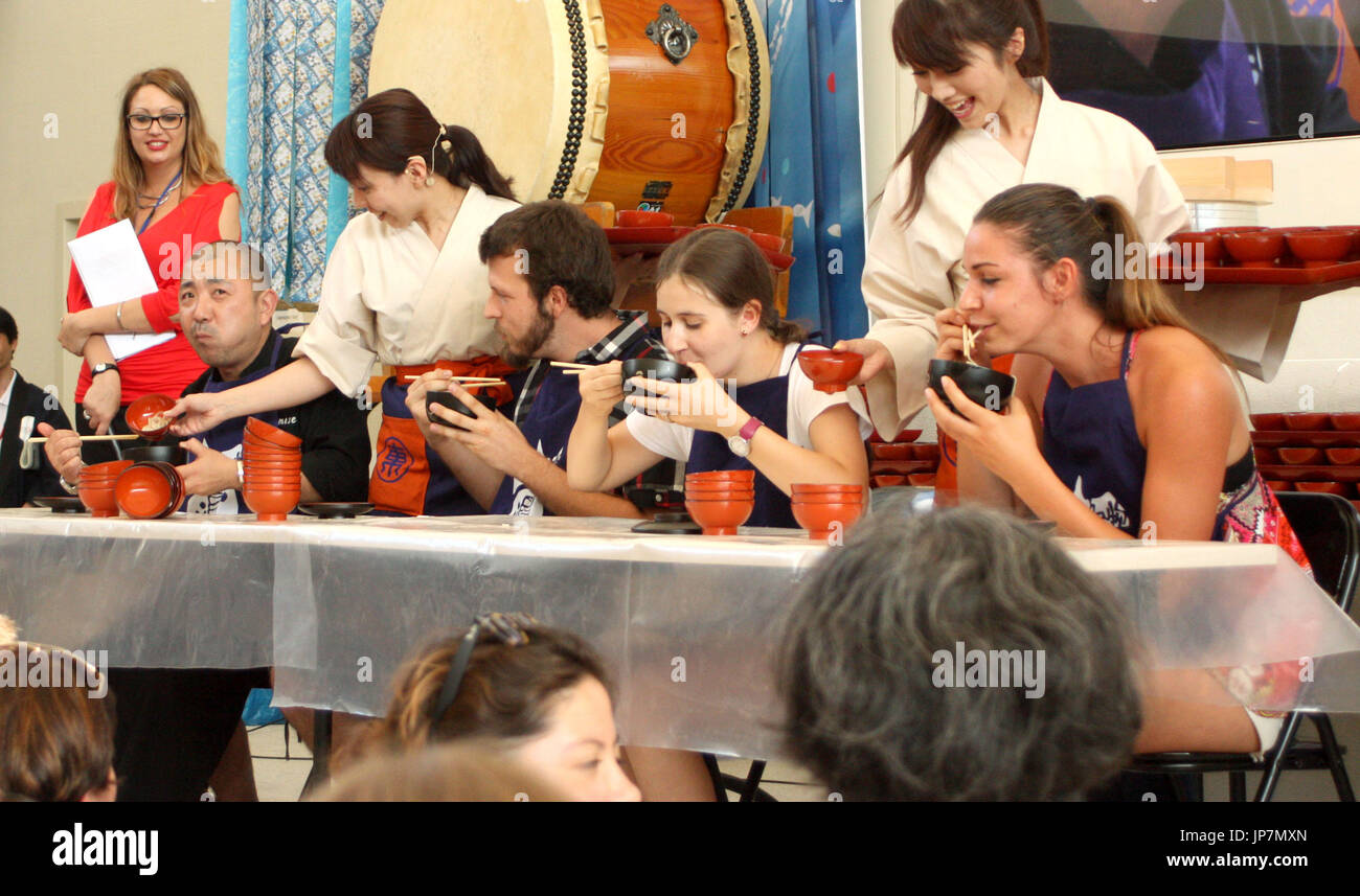 Visitors take part in a speed-eating contest of "wanko soba" Japanese ...