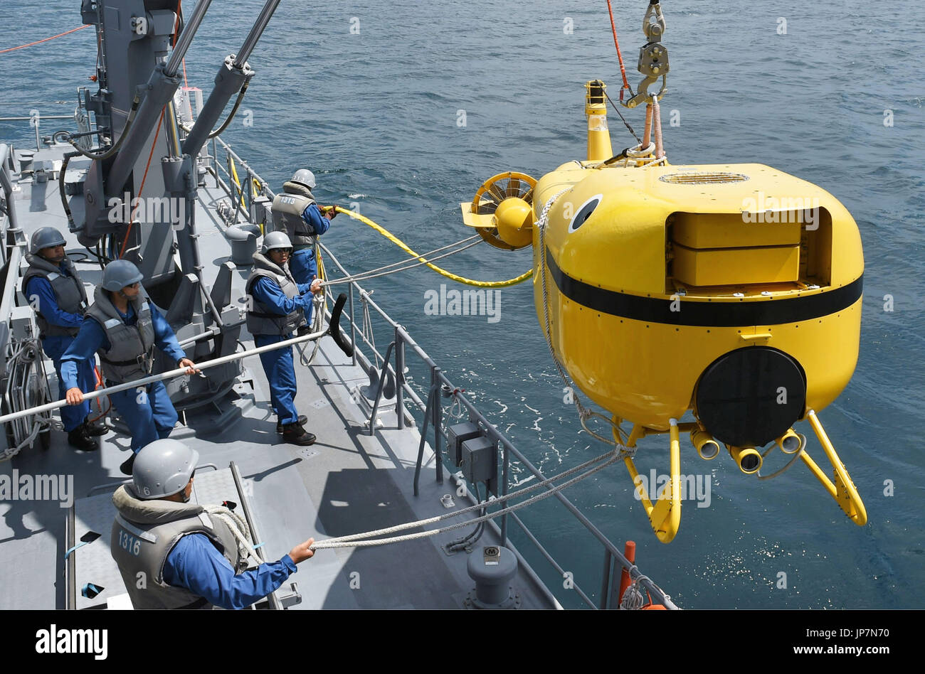 A remote-controlled robot is suspended in the air during a minesweeping ...