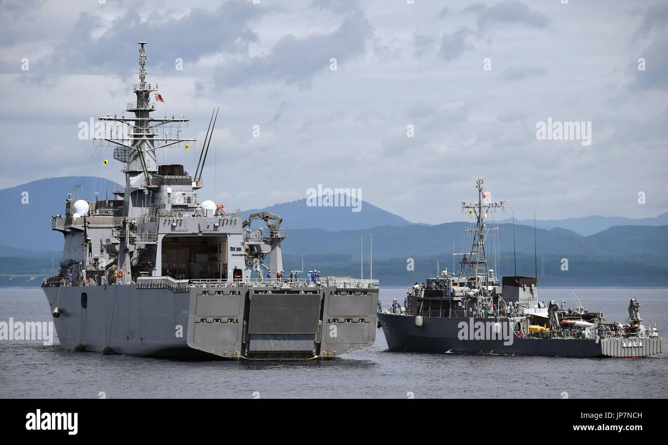 The Japan Maritime Self-Defense Force's minesweeper tender Uraga (L) is ...