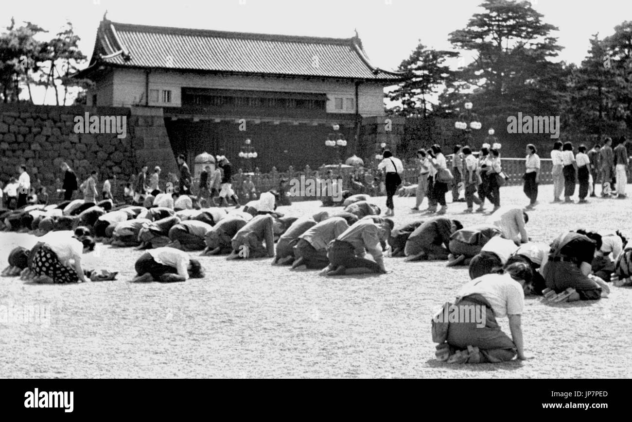 File photo taken Aug. 15, 1945, shows people kneeling down in front of ...