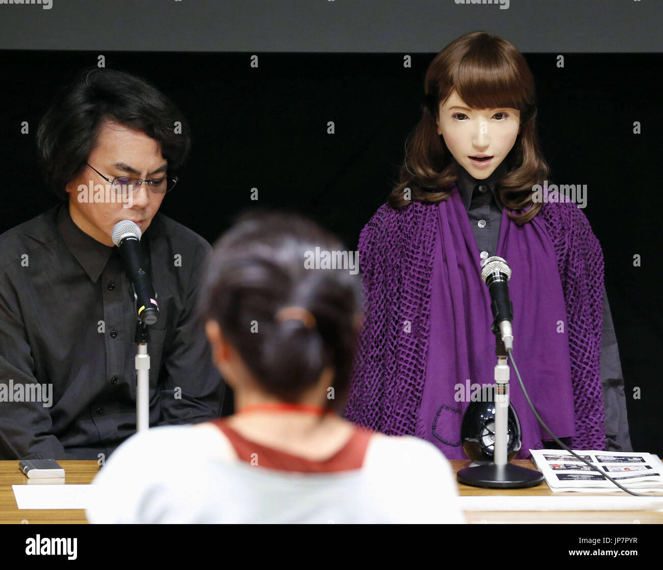 Japanese robotics expert Hiroshi Ishiguro (L), an Osaka University ...