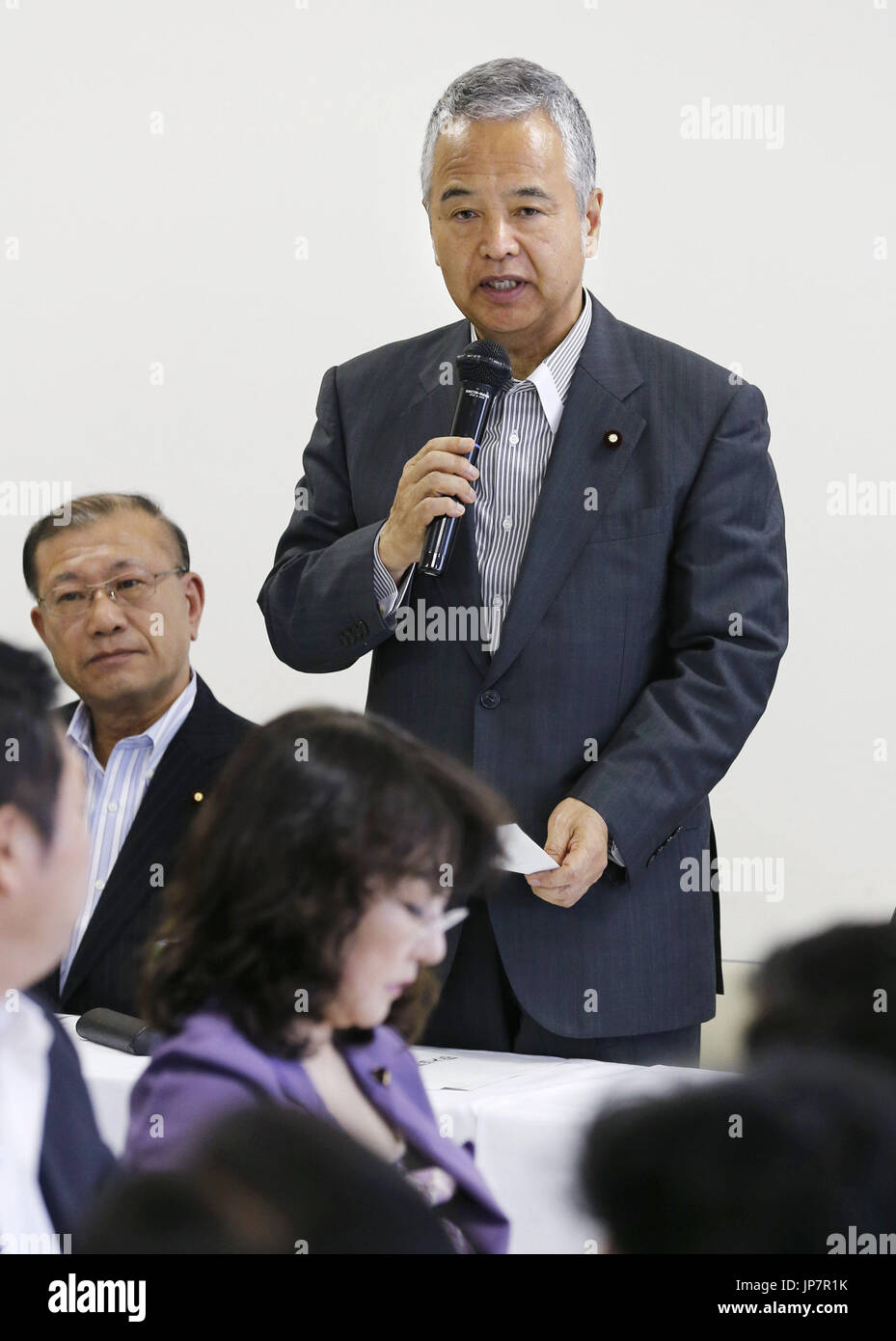 Japanese Economic and Fiscal Policy Minister Akira Amari (standing ...